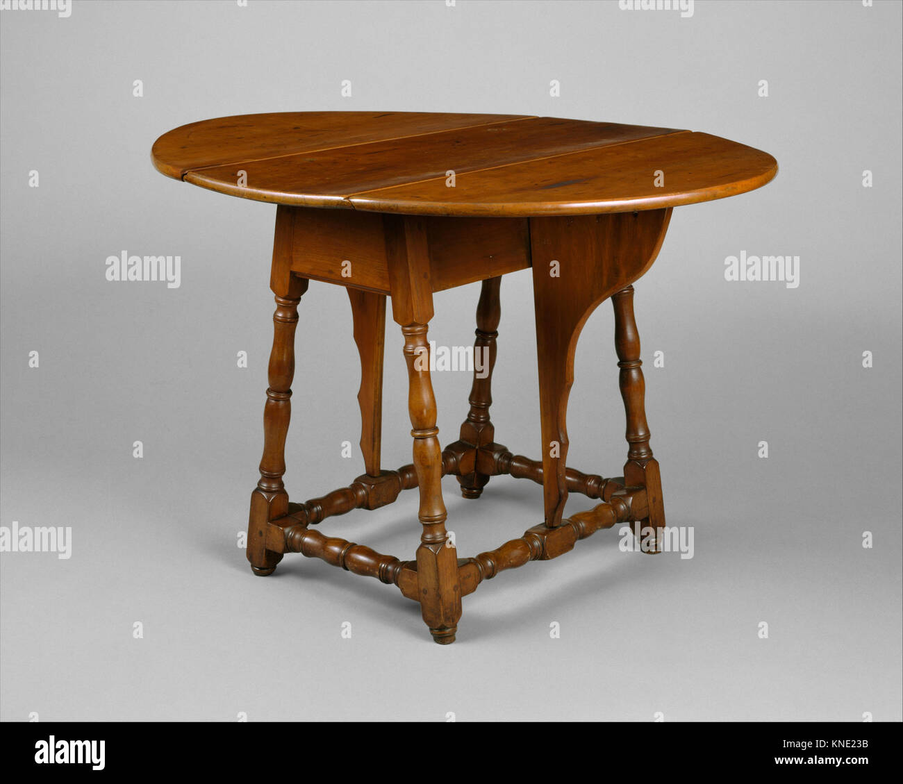 This drop-leaf table, designed for flexibility, features a practical ...