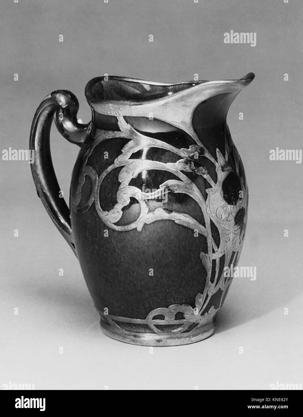 This cream pitcher is a fine example of functional pottery, featuring a ...