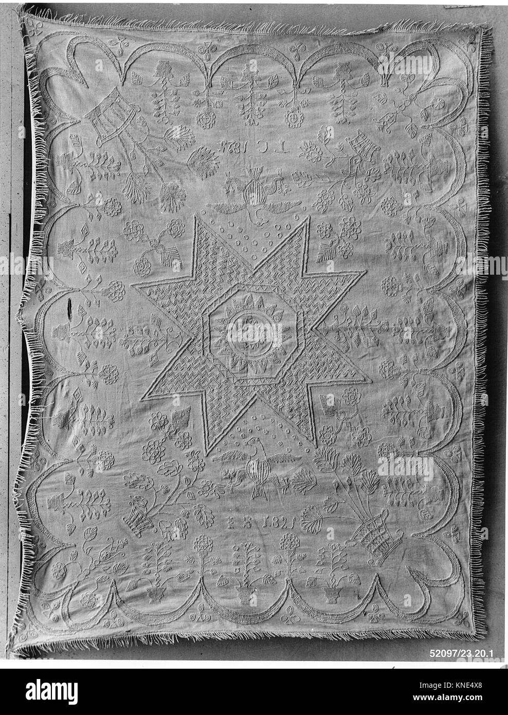 This whitework coverlet features intricate embroidery, highlighting ...