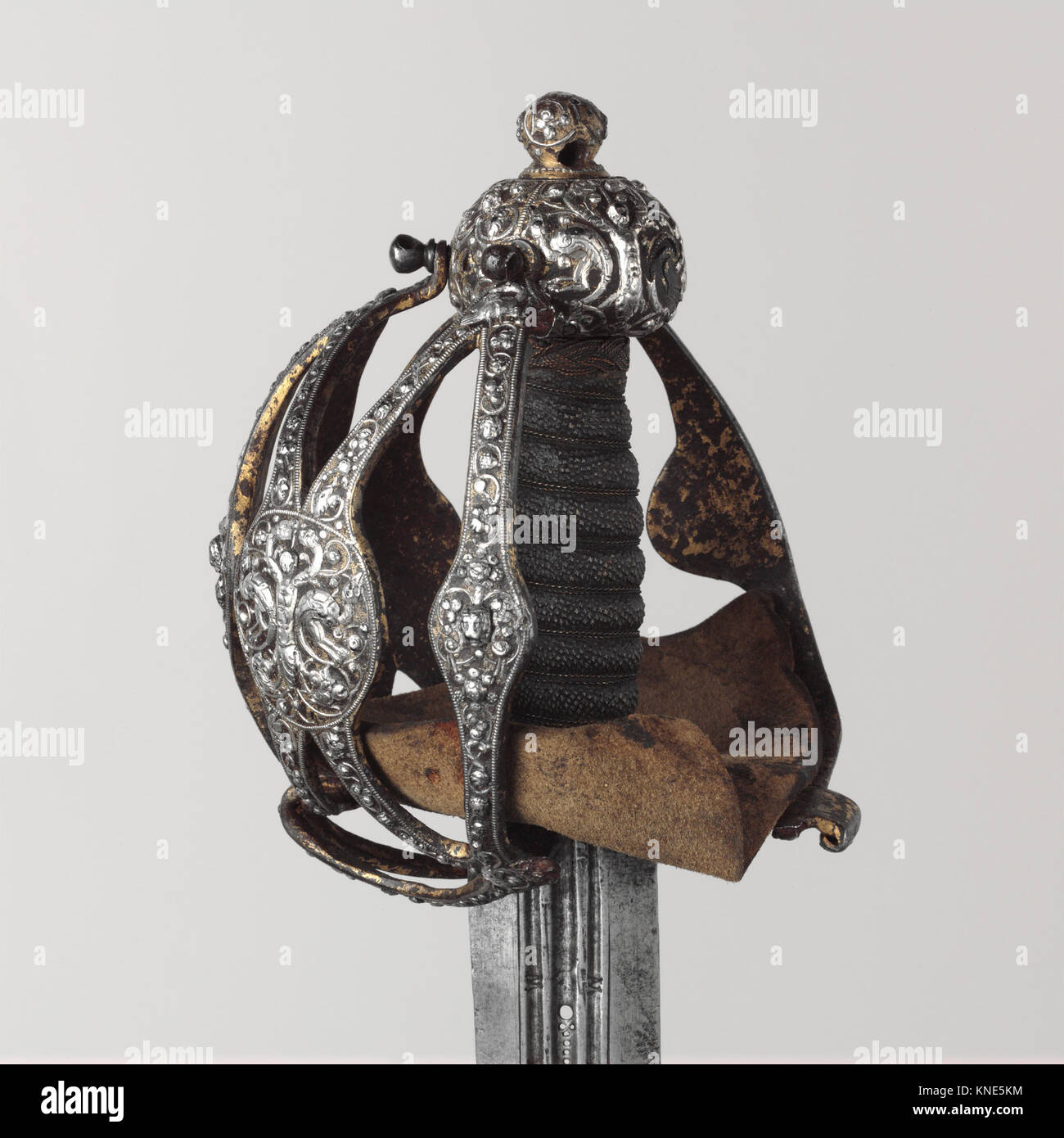 This basket-hilted sword features a protective guard and distinctive ...