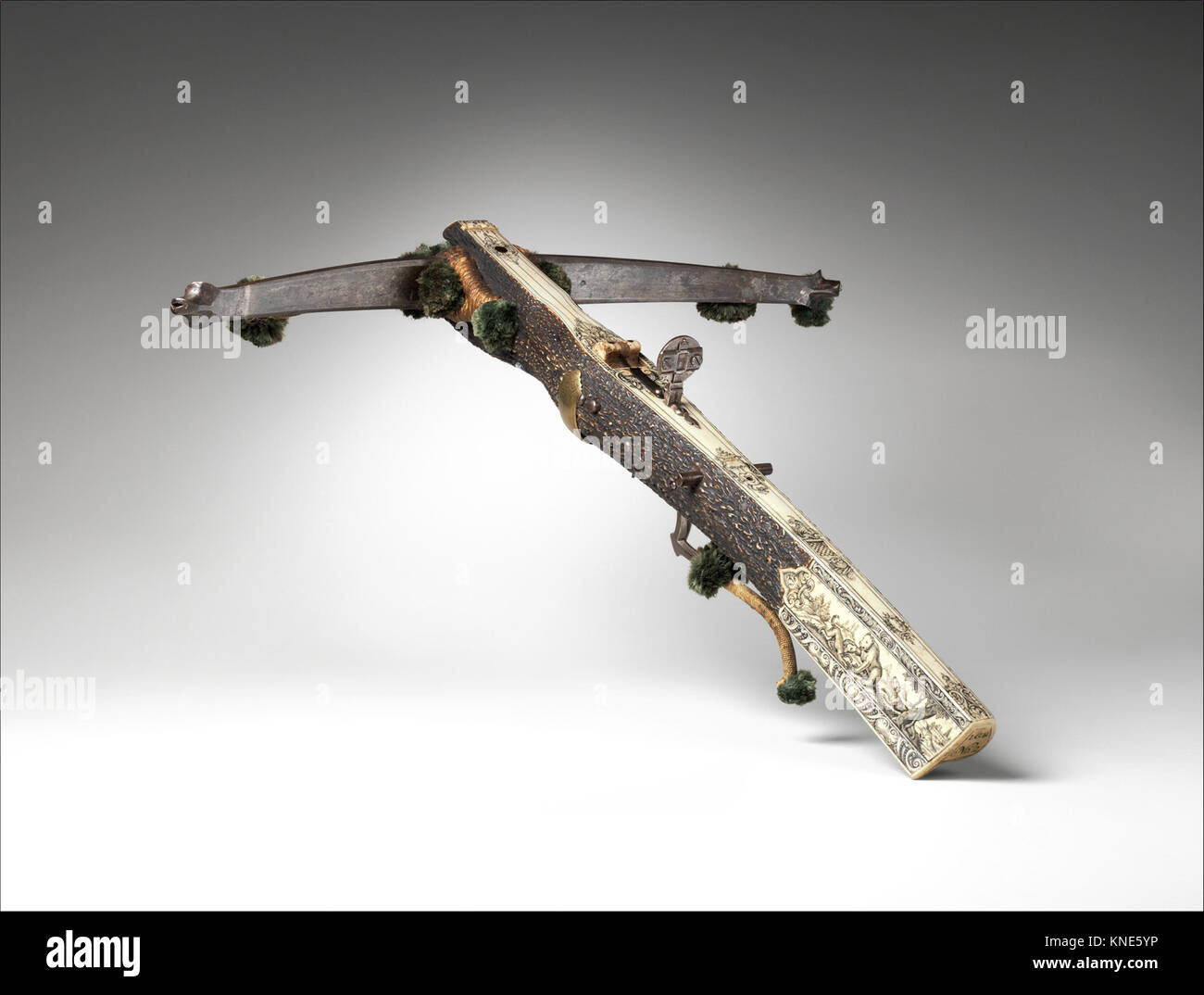 A crossbow featuring a cranequin, a mechanical device used to wind the ...