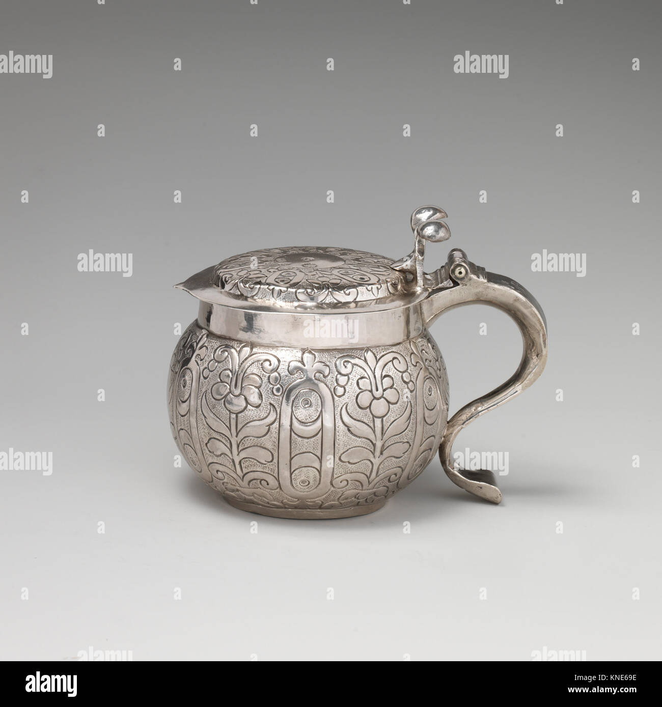 This child's tankard is a small, ornately designed vessel used for ...