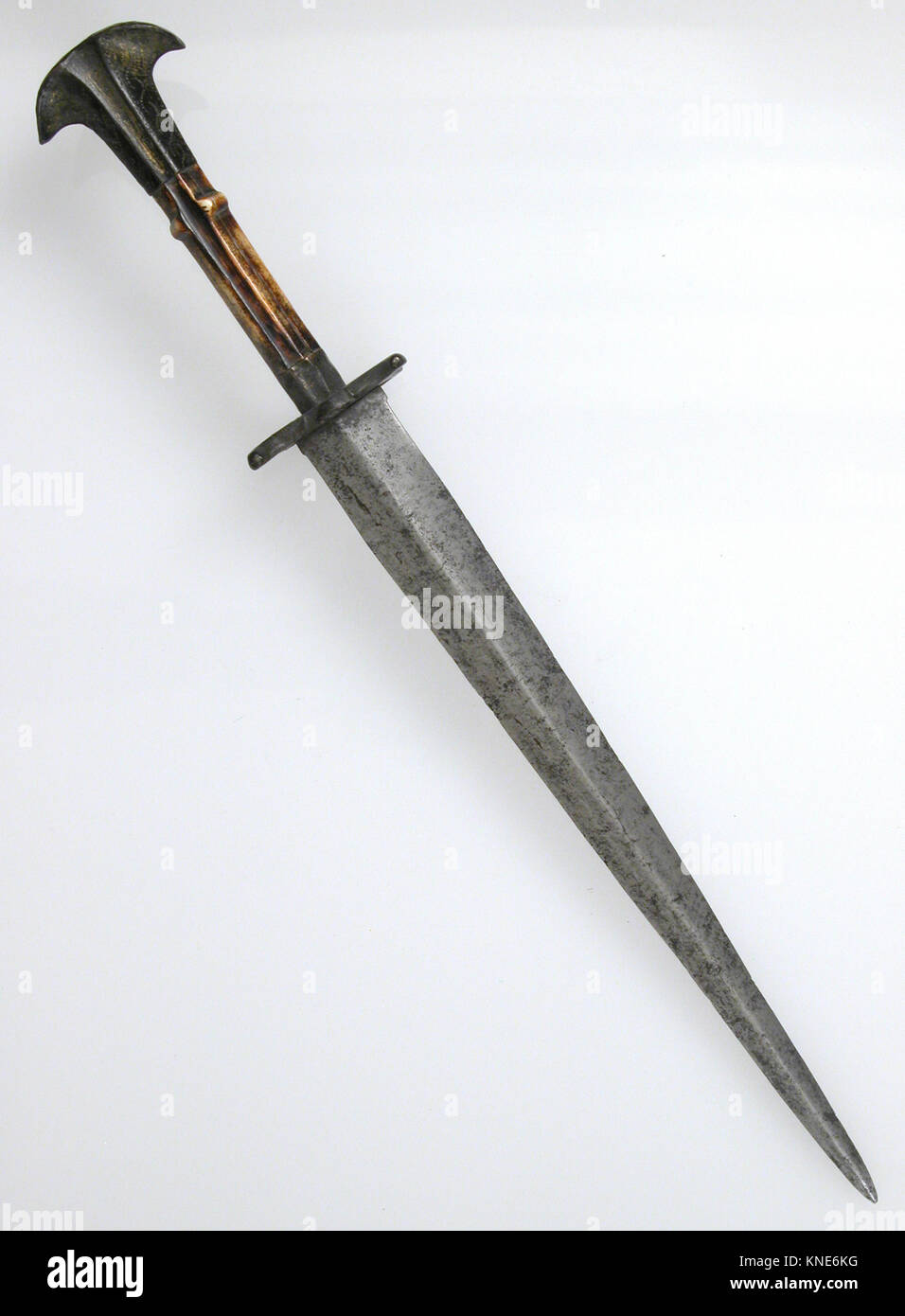 Ancient dagger with a metal blade and decorative hilt, representing the ...