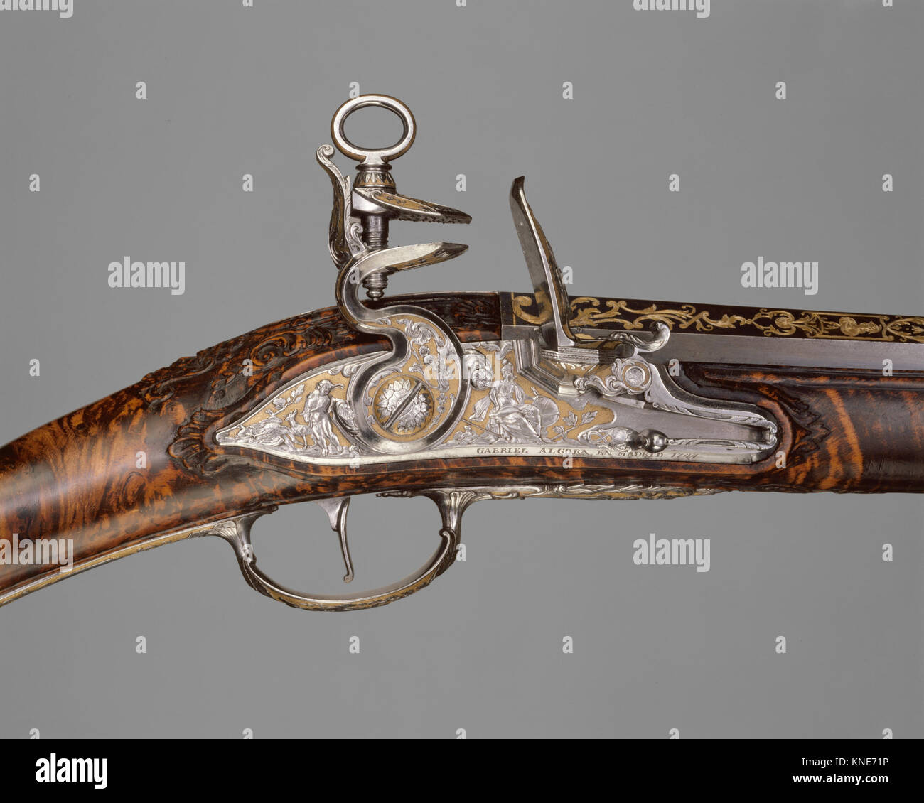 This flintlock gun, styled in the fashionable design of its period ...