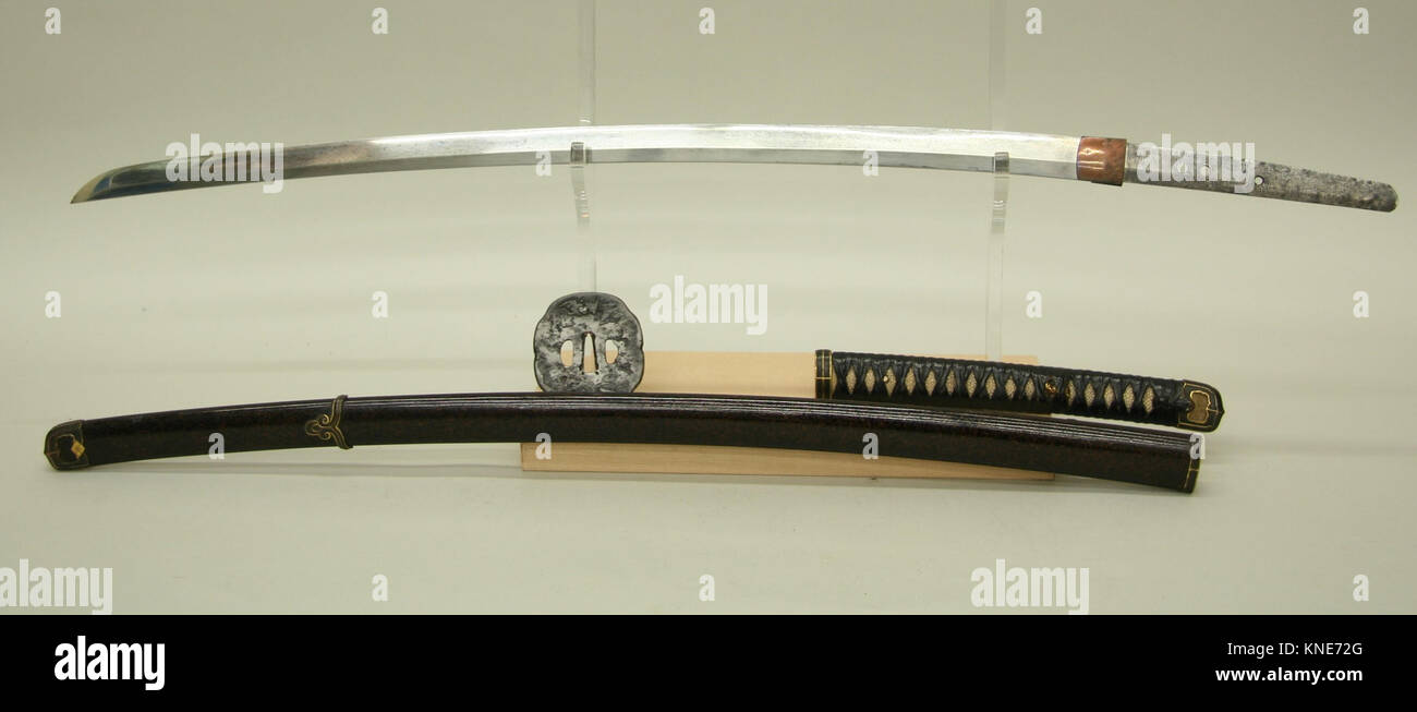 A katana blade with its accompanying mounting, reflecting the ...
