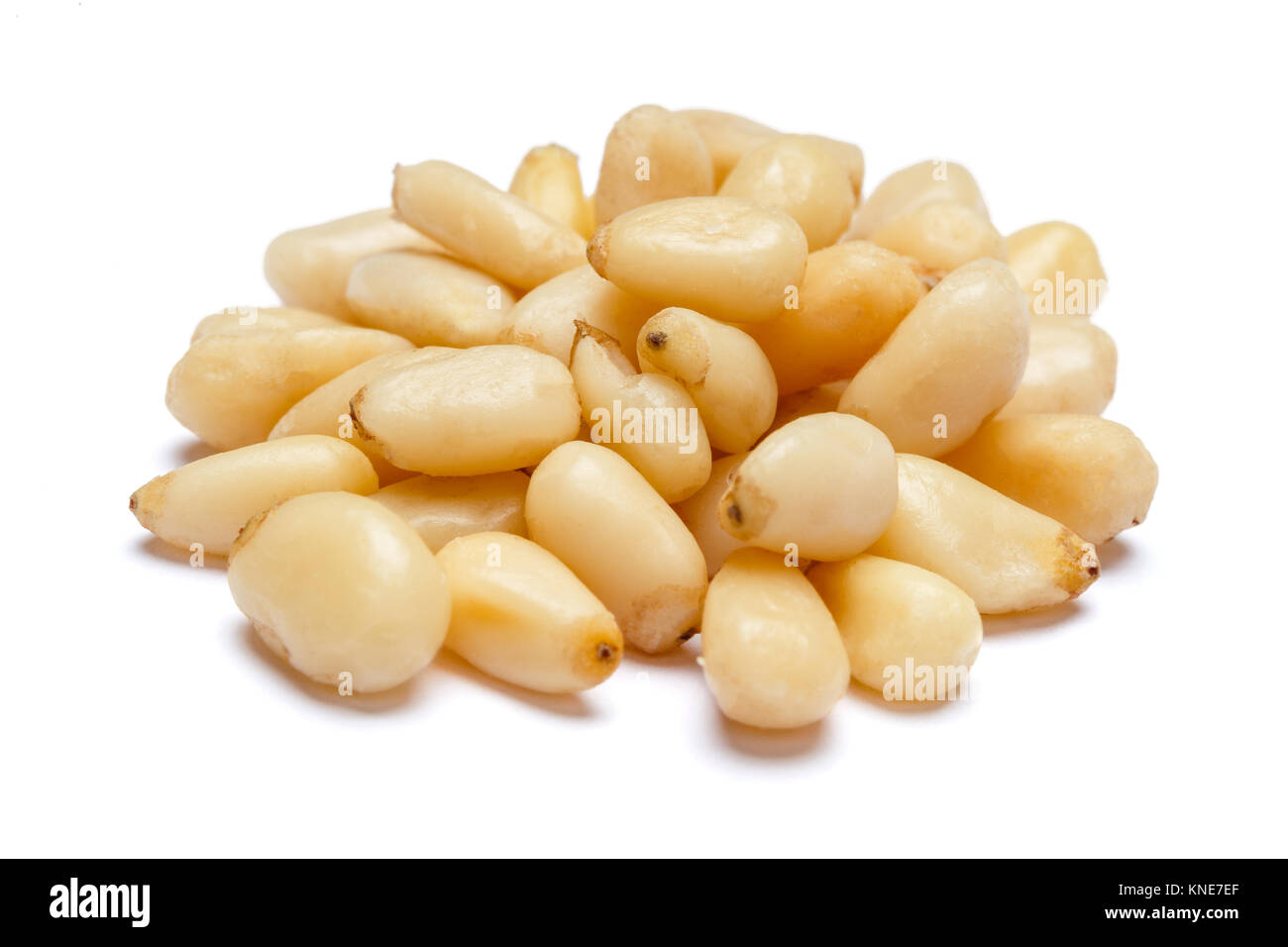 Pine nuts isolated on white Stock Photo - Alamy