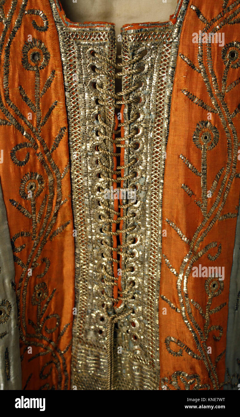 This dress represents historical fashion, featuring intricate textile ...