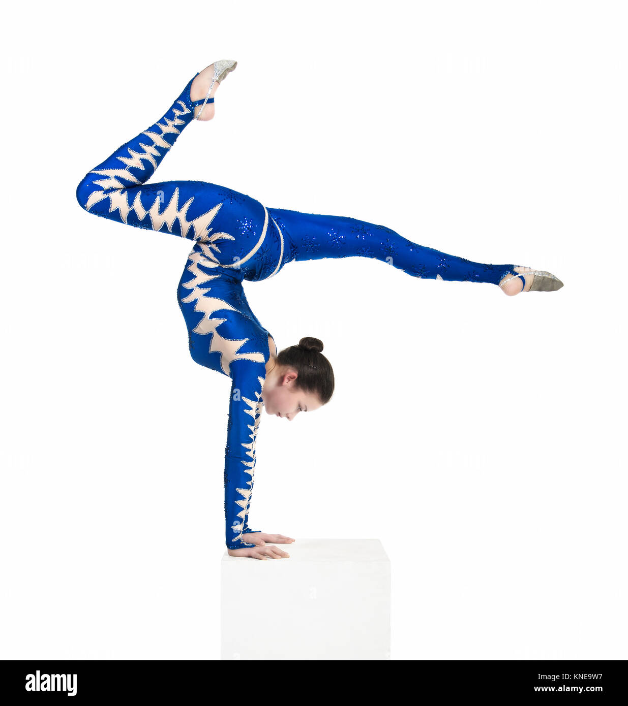 Acrobat does gymnastics, isolated image on a white background. A young ...