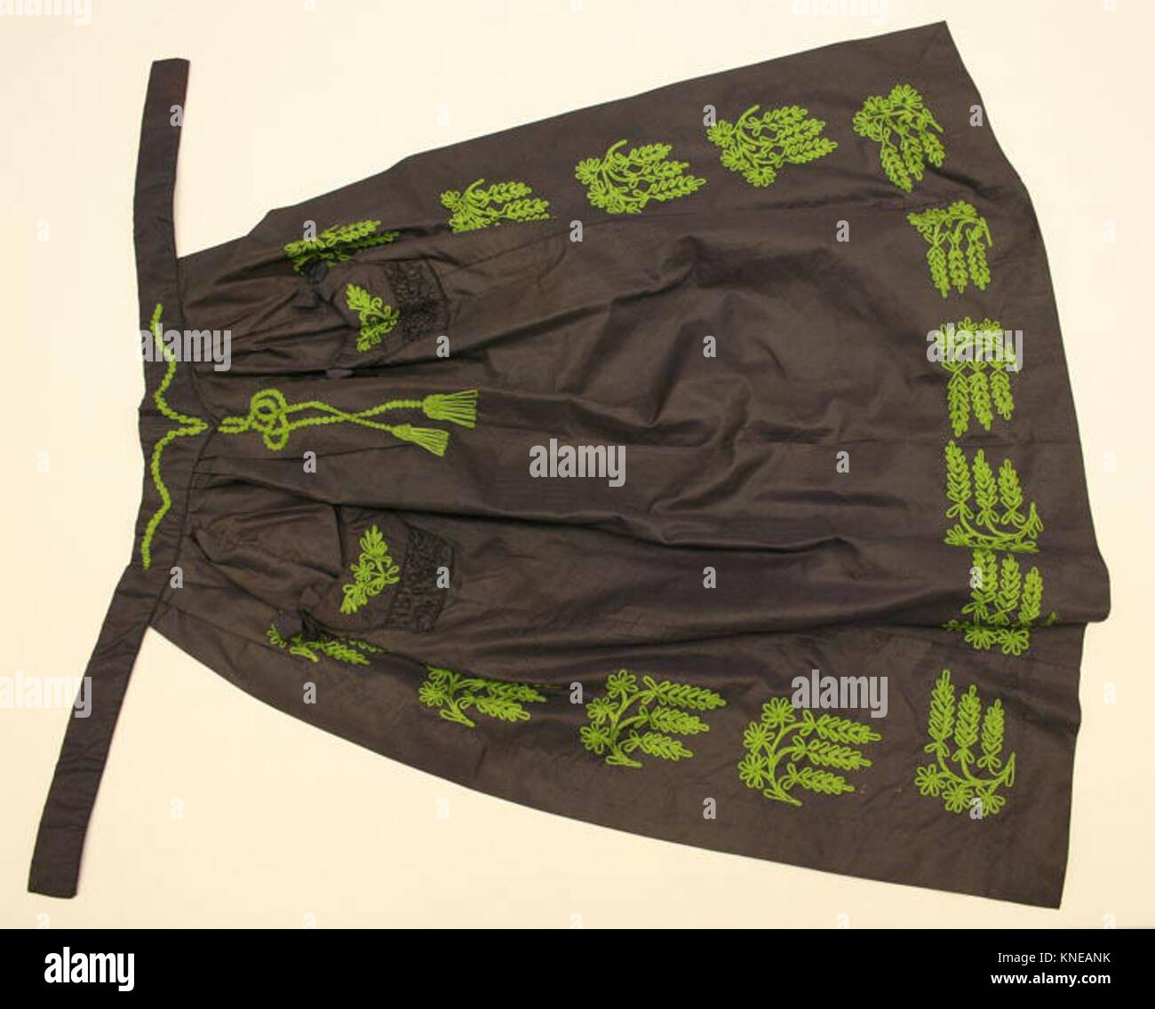 This apron is a practical garment with decorative elements, typical of ...