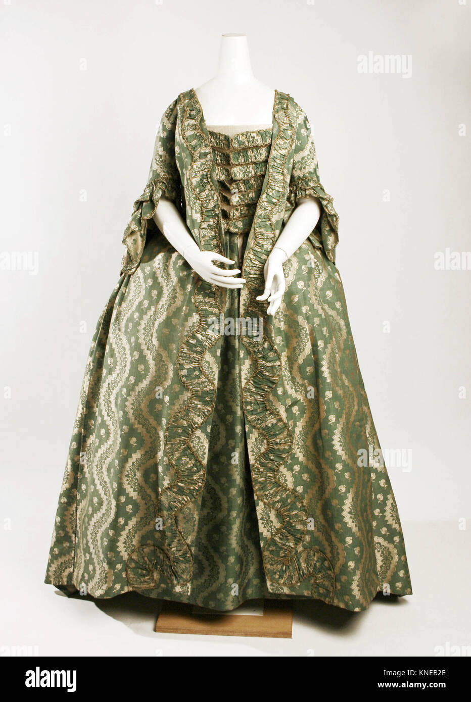A historical dress showcasing intricate fabric work and design ...