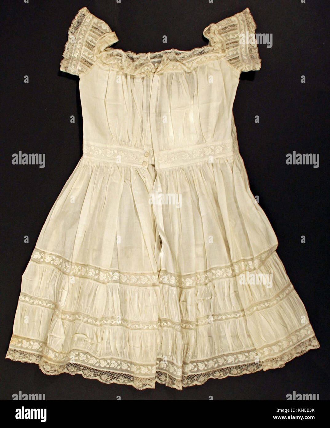 This dress, showcasing intricate fabric design, exemplifies the fashion ...