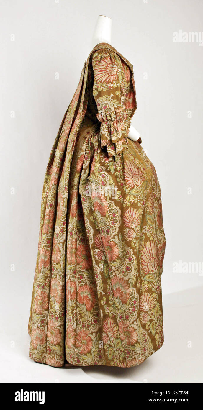 This dress showcases the fashion and design of its period, emphasizing ...