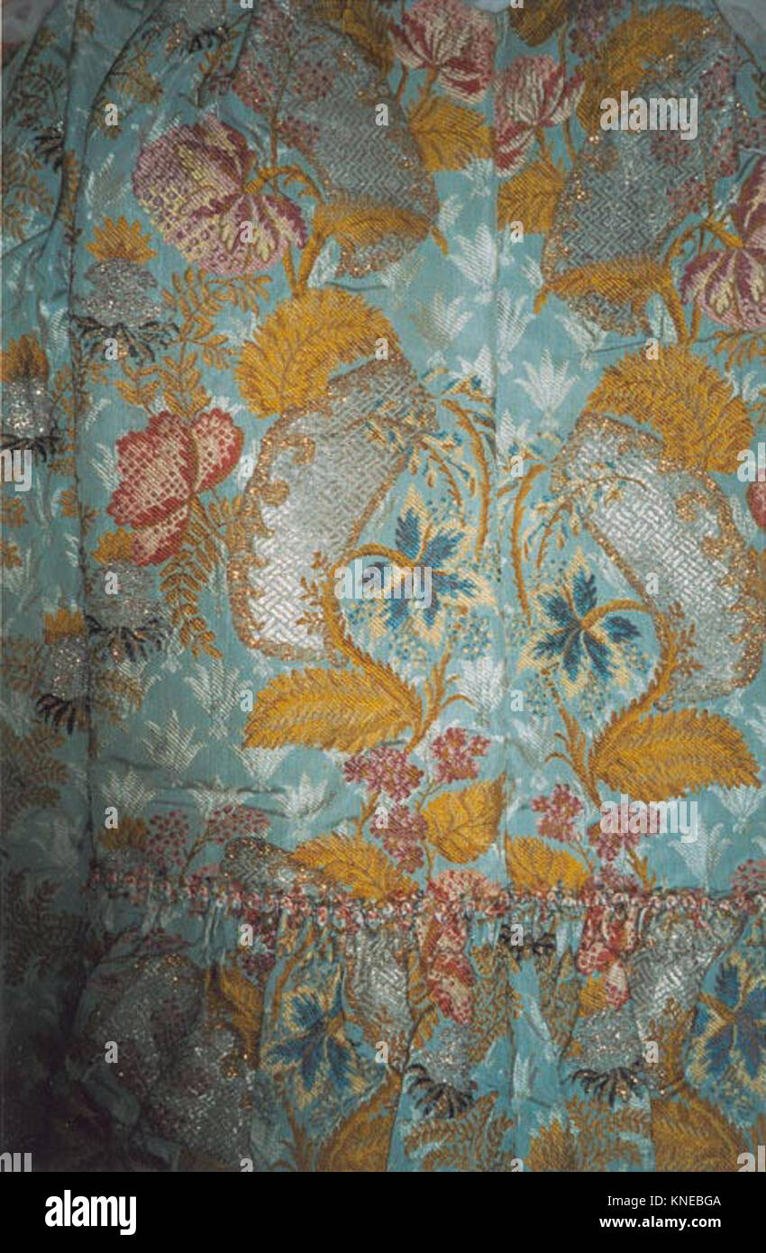 This dress exemplifies fashion from its era, characterized by detailed ...