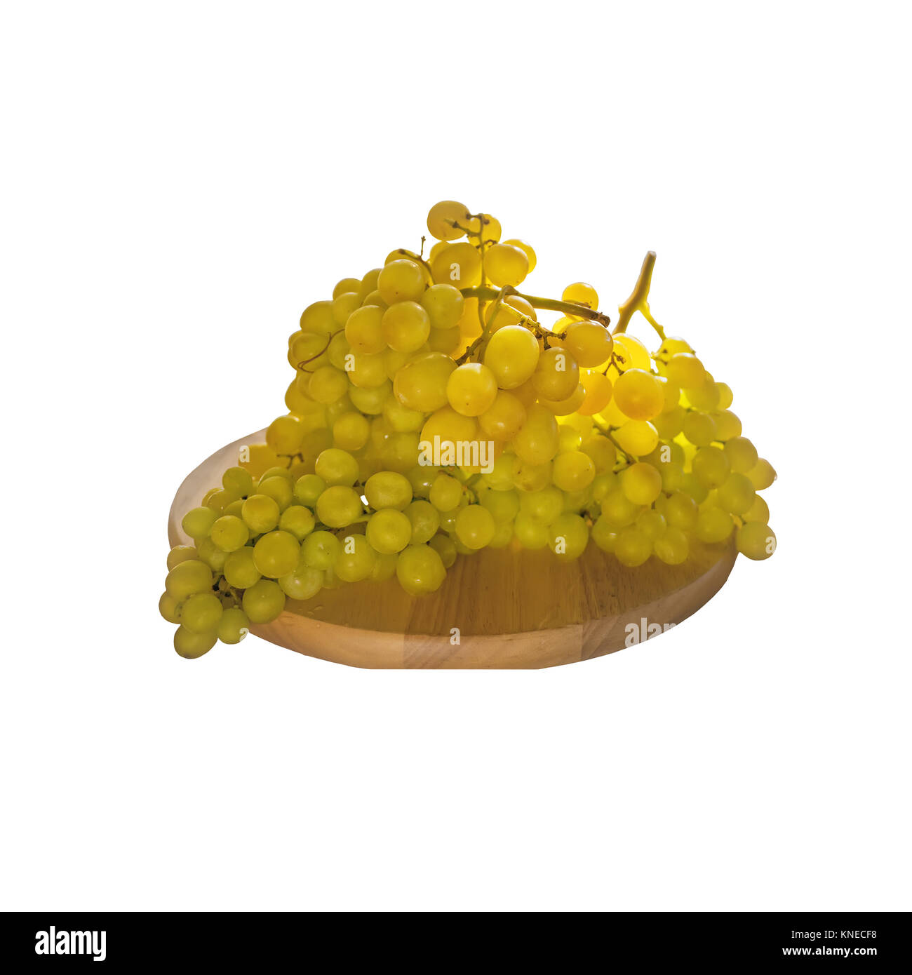 Beautiful big bunch of white grapes lying on a round Board. Isolated on ...