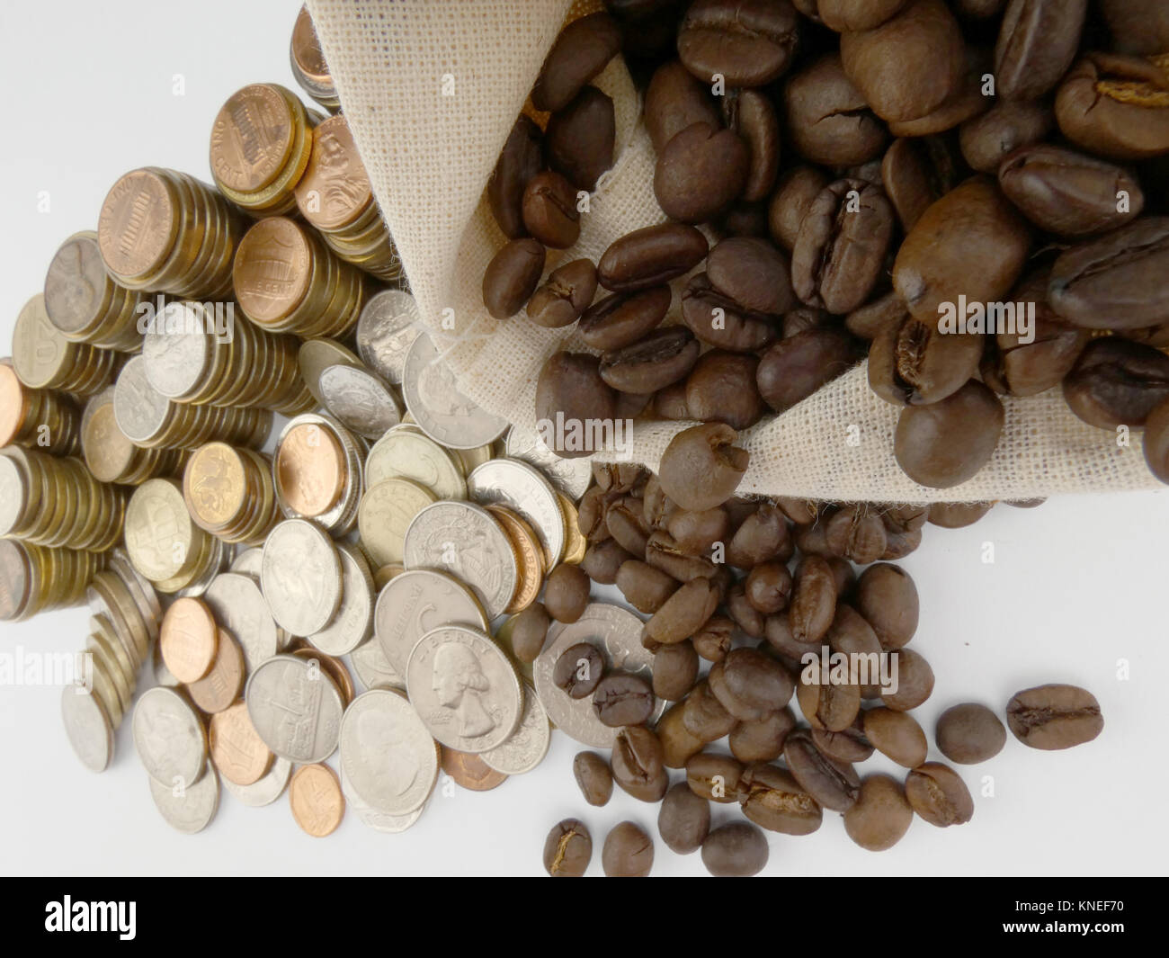 Coffe beans with coins isolated on white background Stock Photo - Alamy