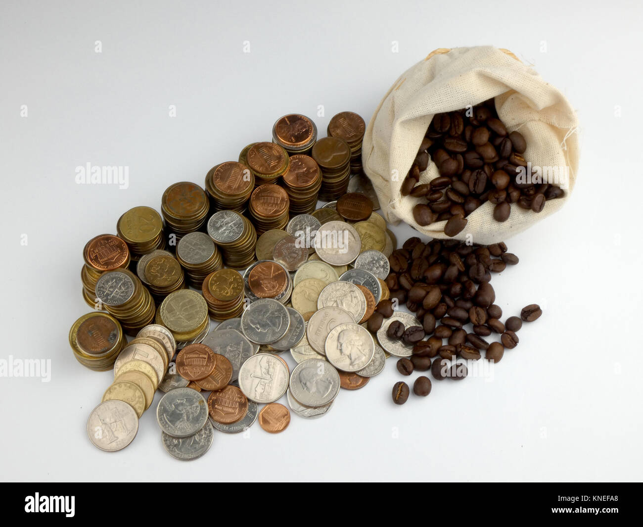 Coffe beans with coins isolated on white background Stock Photo - Alamy
