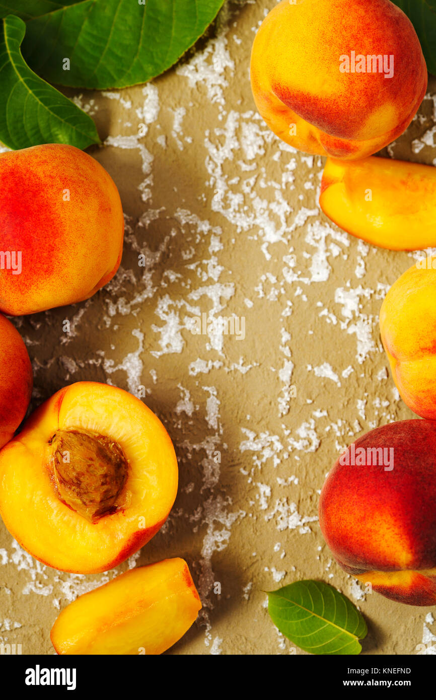 Peaches on a textured background Stock Photo - Alamy