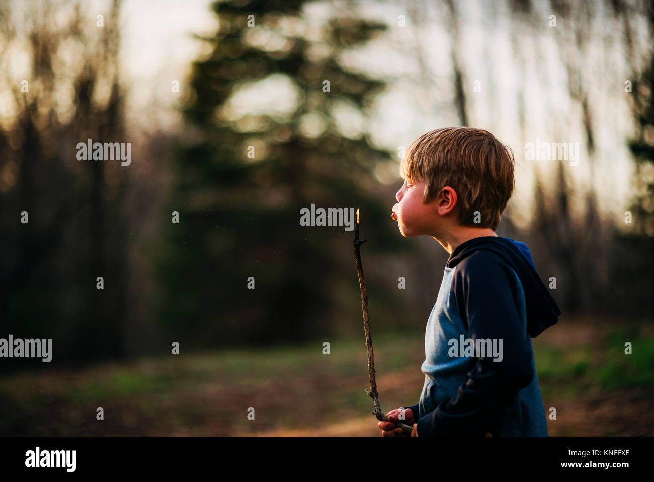 Boy blowing a smoking stick Stock Photo - Alamy
