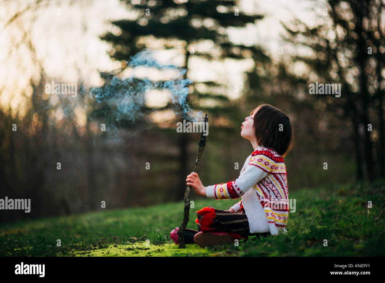 Girl blowing a smoking stick Stock Photo - Alamy