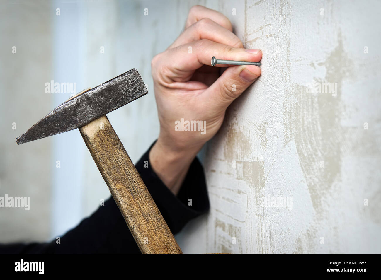Hand holding hammer nail hi-res stock photography and images - Alamy