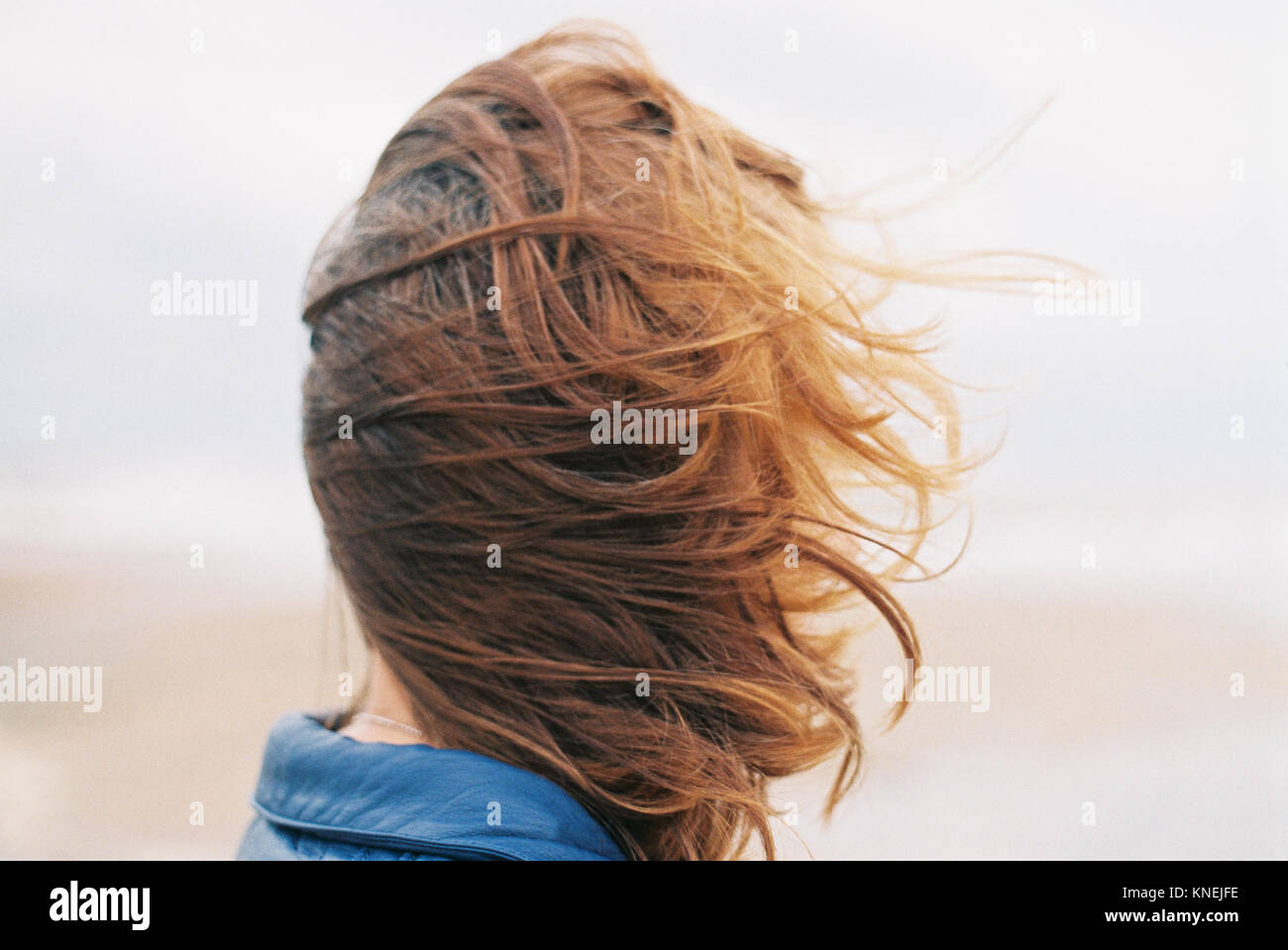Close-up of a woman with windswept hair Stock Photo - Alamy