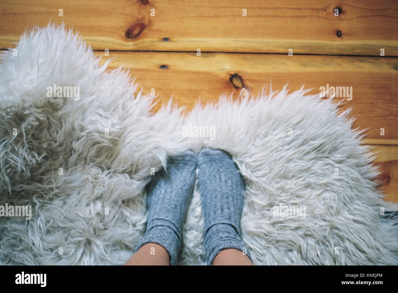 Woman's feet wearing socks on a rug Stock Photo - Alamy