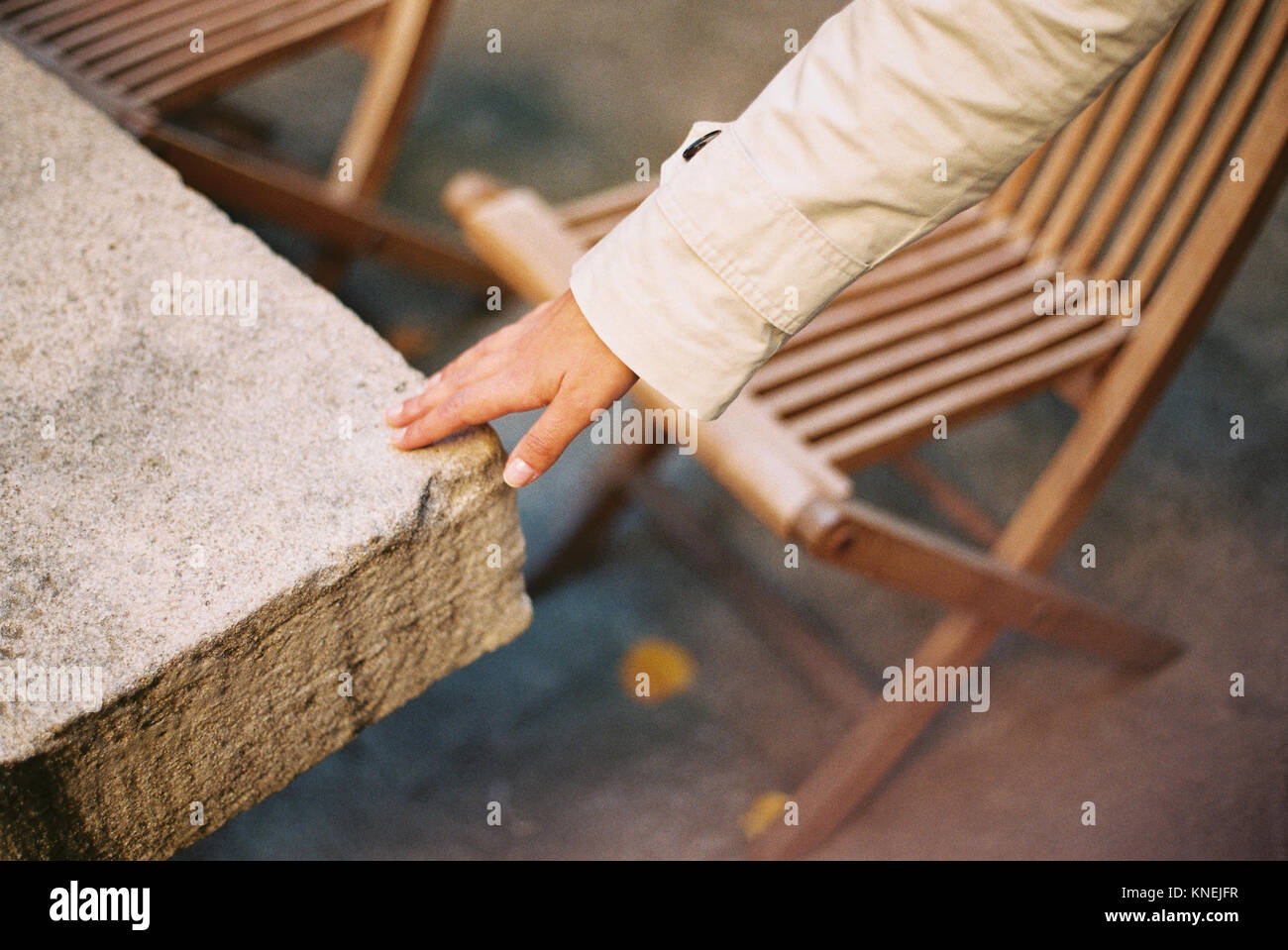Woman's hand touching a stone table Stock Photo - Alamy