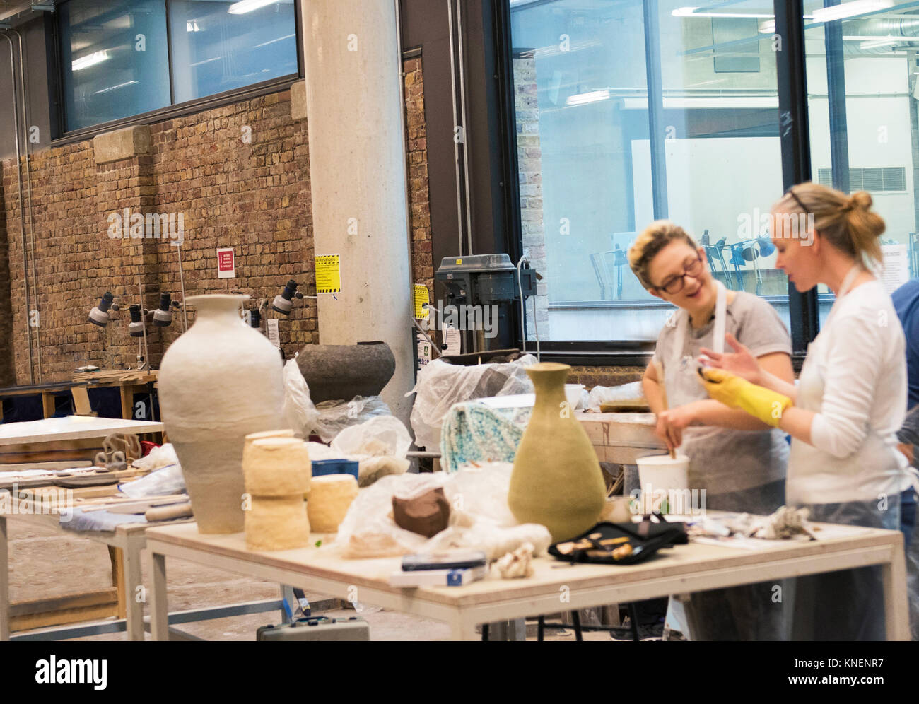 Colleagues in art studio making pottery Stock Photo - Alamy