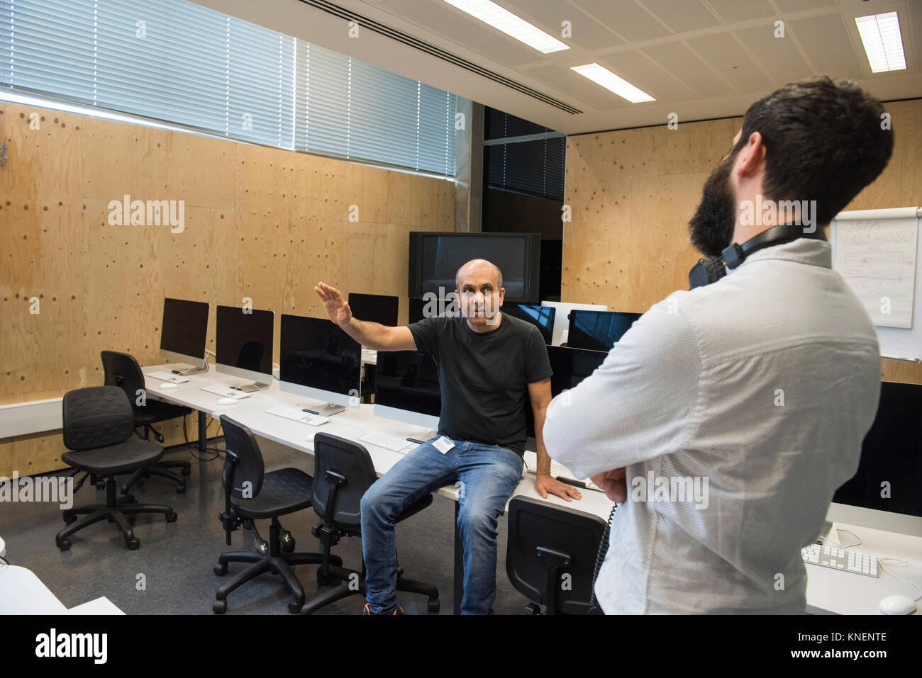 Colleagues chatting in computer room Stock Photo - Alamy