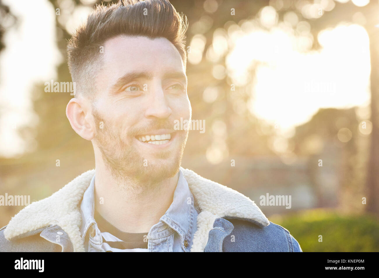 Hazy lens flare portrait of bearded young man Stock Photo - Alamy