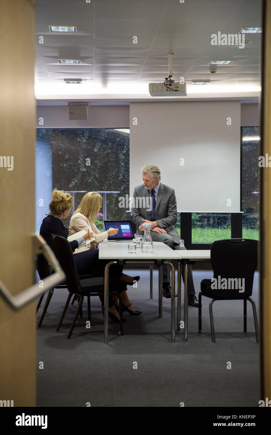 Colleagues in conference room having meeting Stock Photo - Alamy