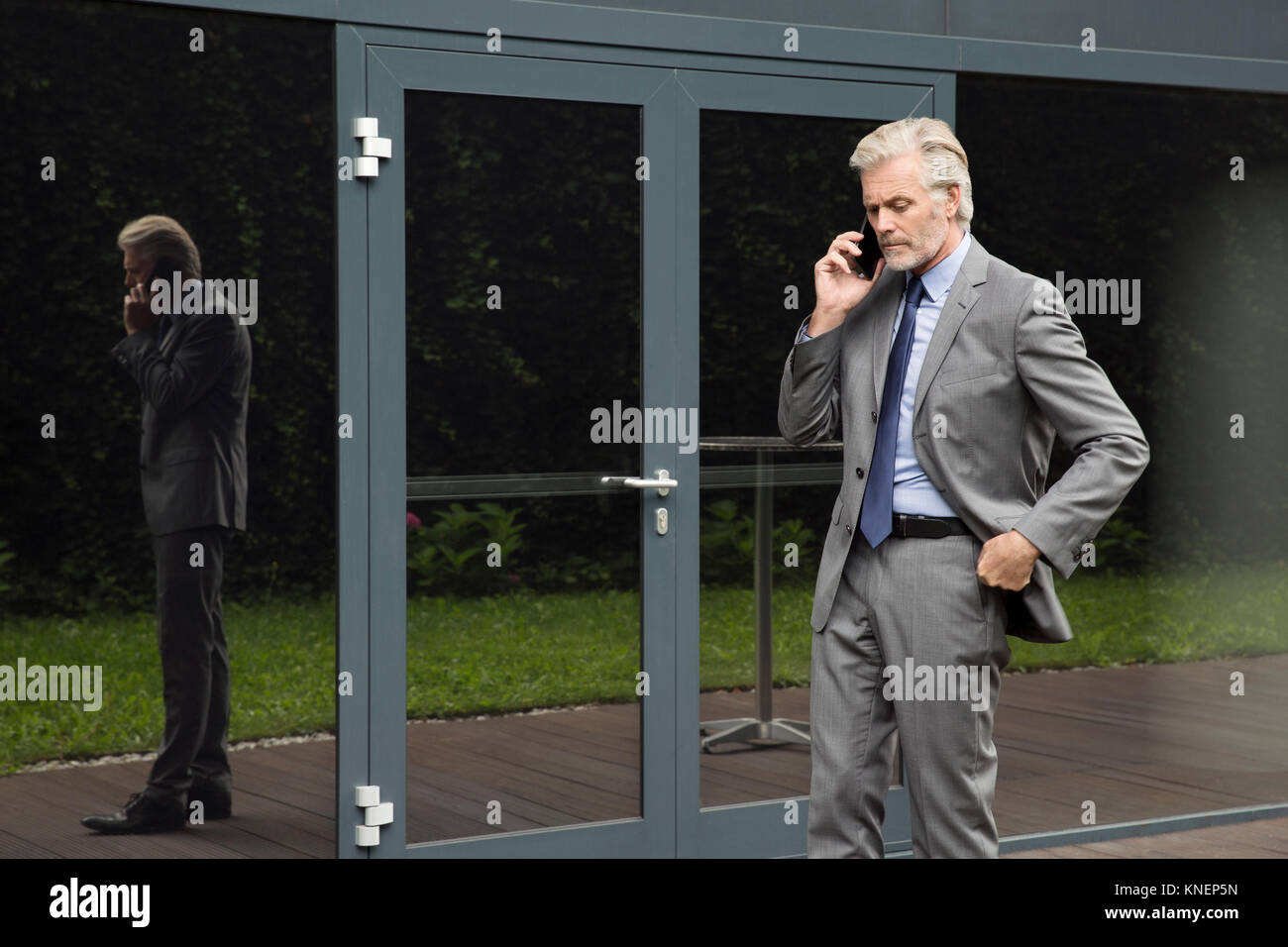 Businessman making telephone conversation on smartphone Stock Photo - Alamy