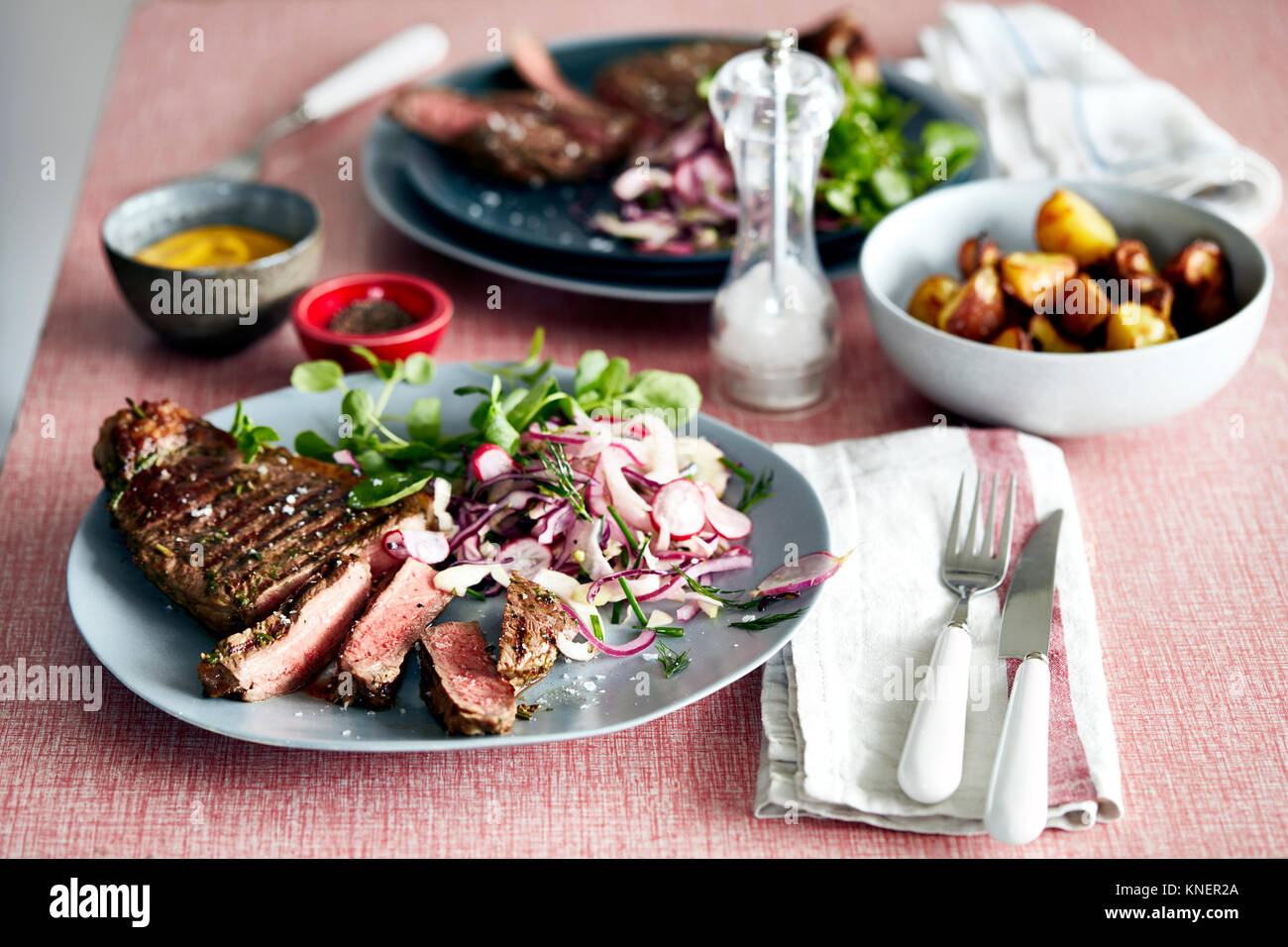 Steak meal for two on table Stock Photo - Alamy