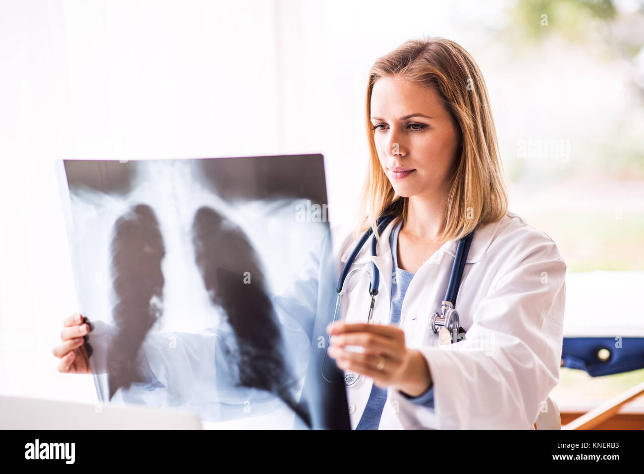 Female doctor with x-ray , working at the office desk Stock Photo - Alamy
