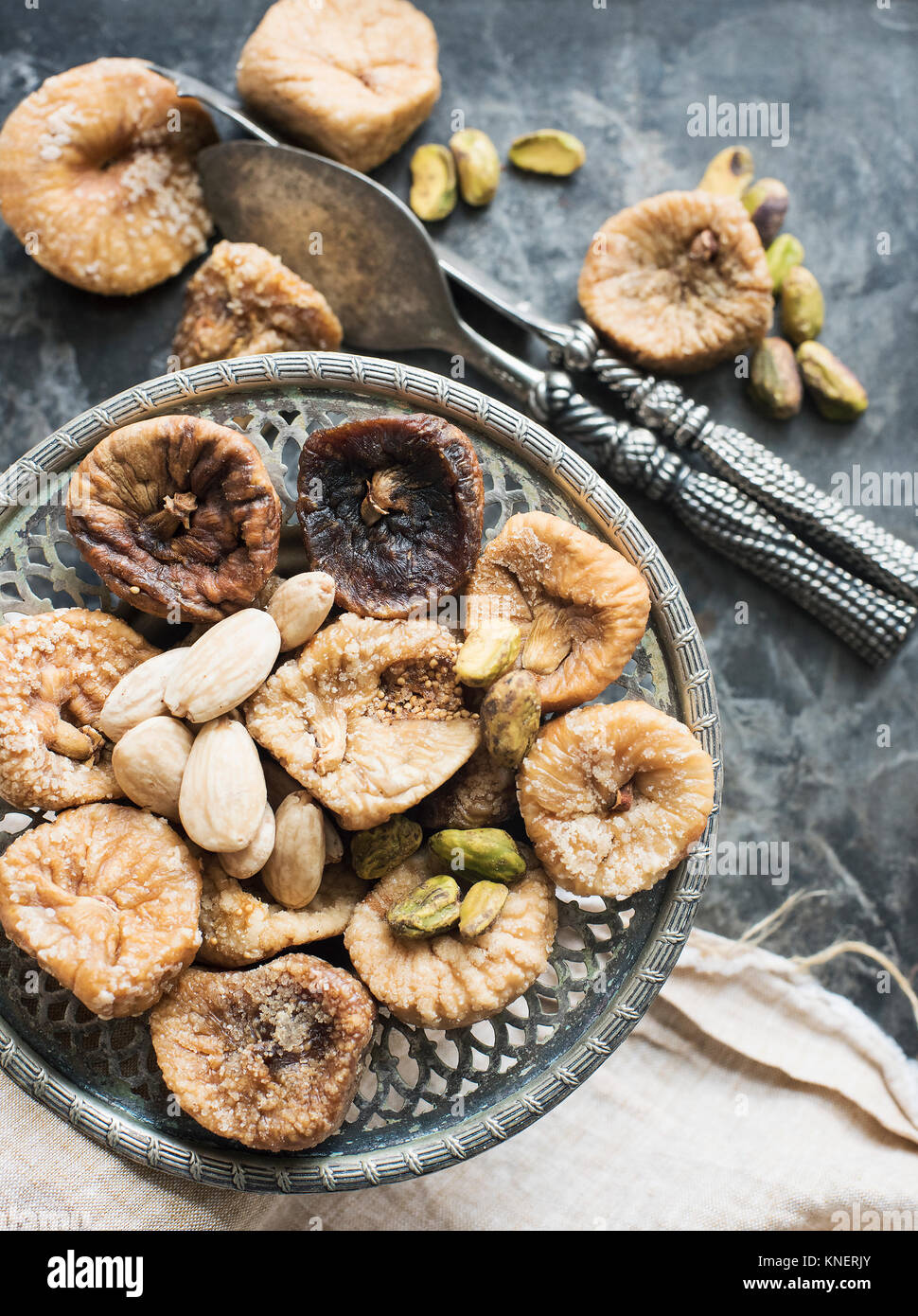 Dried figs and nuts served on antique plate, close-up Stock Photo - Alamy