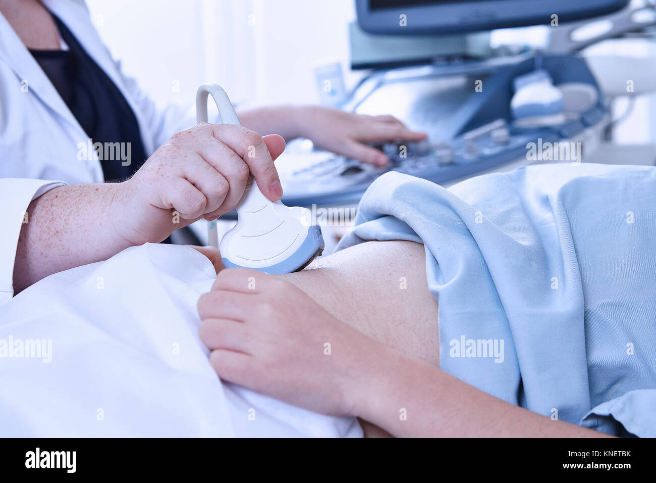 Cropped view of sonographer giving pregnant patient ultrasound scan ...