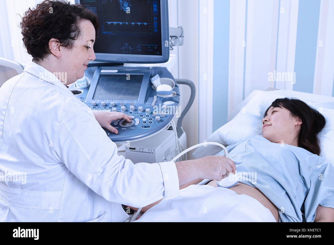 Sonographer giving pregnant patient ultrasound Stock Photo - Alamy