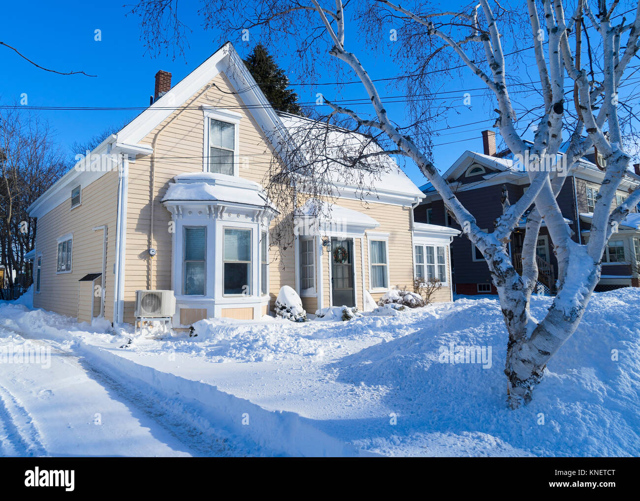 Older traditional house in wintertime in a North American neighborhood ...