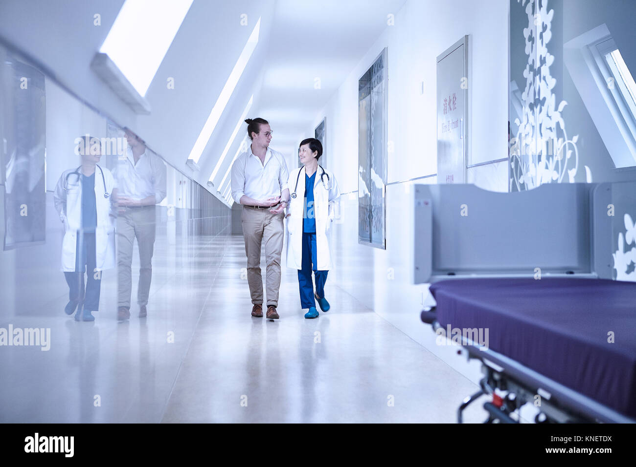 Doctors walking in hospital corridor Stock Photo - Alamy
