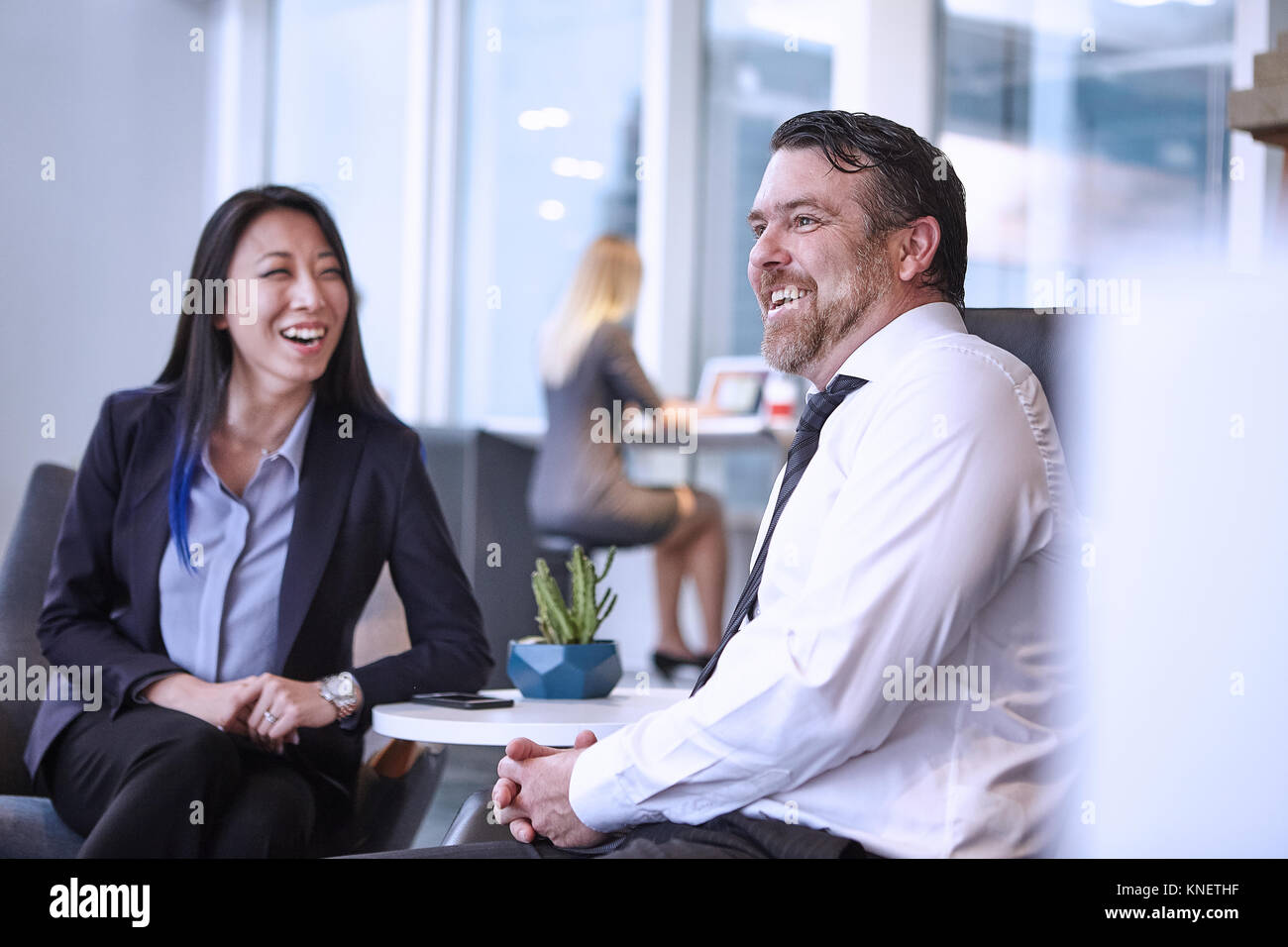 Colleagues in office laughing Stock Photo - Alamy