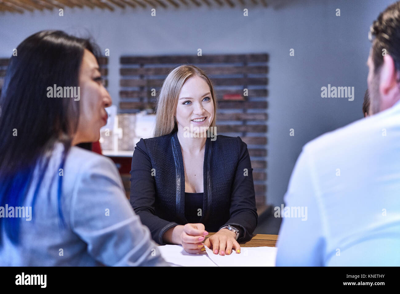 Smiling businesswoman communicating colleagues meeting hi-res stock ...