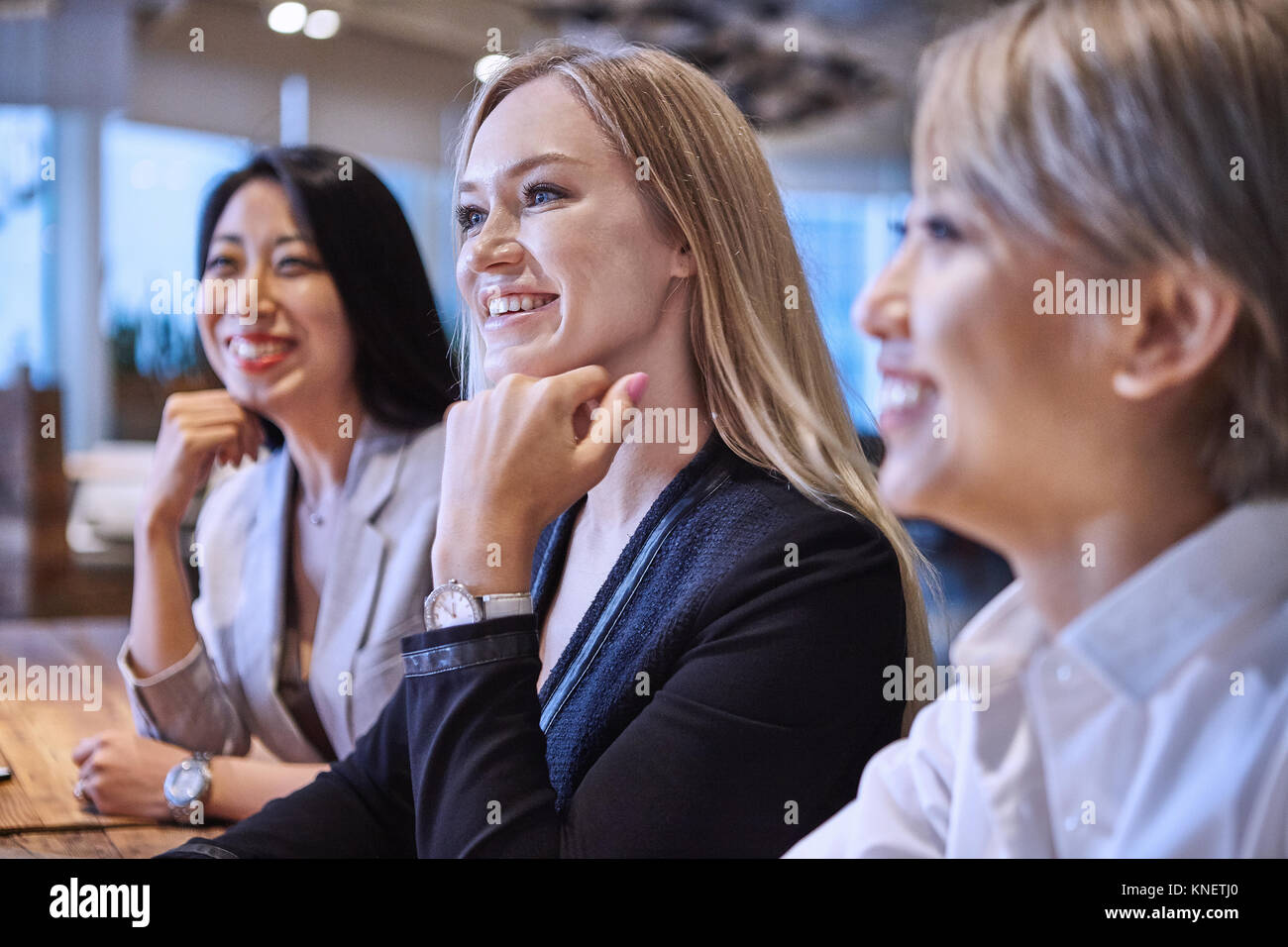 Friends side by side looking away smiling Stock Photo - Alamy