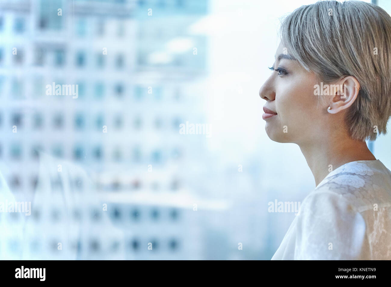 Portrait woman short hair looking out window hi-res stock photography ...