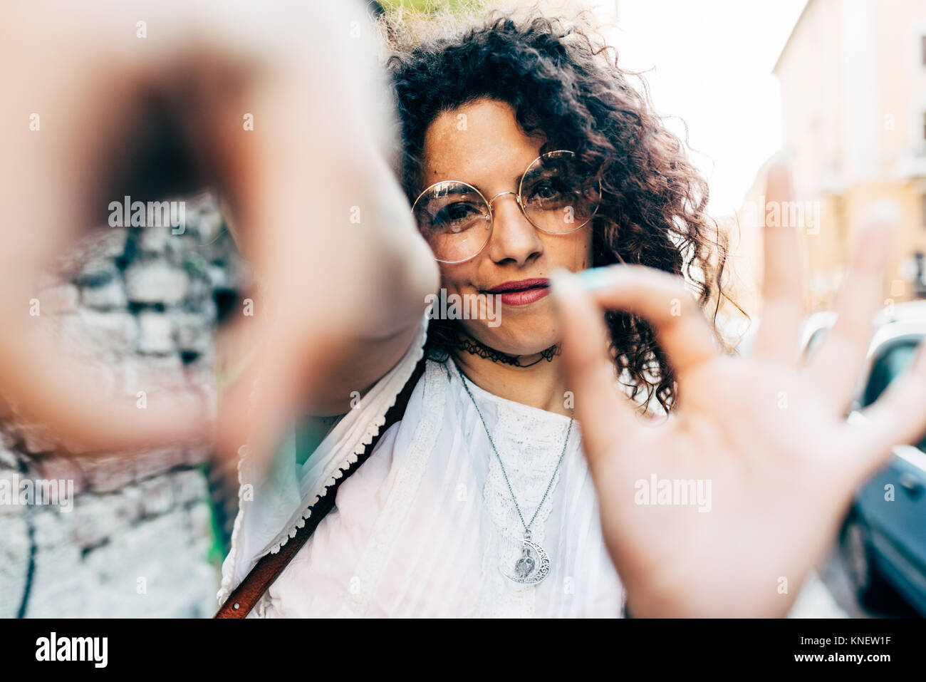 Curly woman wearing hand hi-res stock photography and images - Alamy
