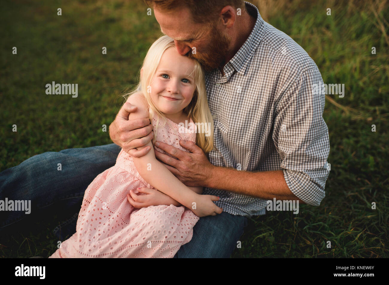 Daughter sitting on fathers lap hi-res stock photography and images - Alamy