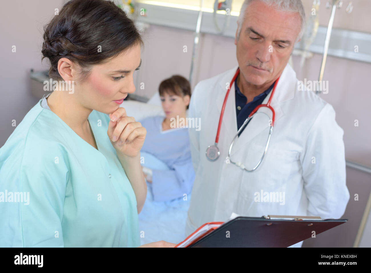 Doctors deliberating over patient's notes Stock Photo - Alamy