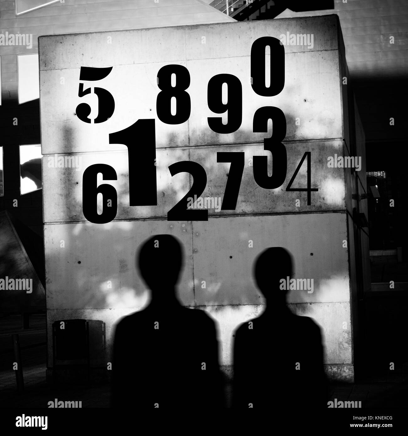 Numbers on a wall. Silhouettes of people Stock Photo - Alamy