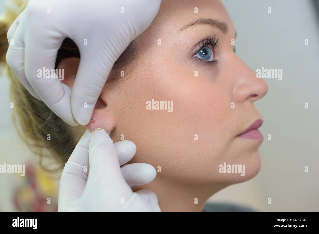 having ear pierced Stock Photo - Alamy