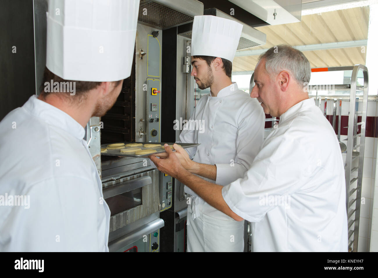 Trainee chef at oven Stock Photo - Alamy
