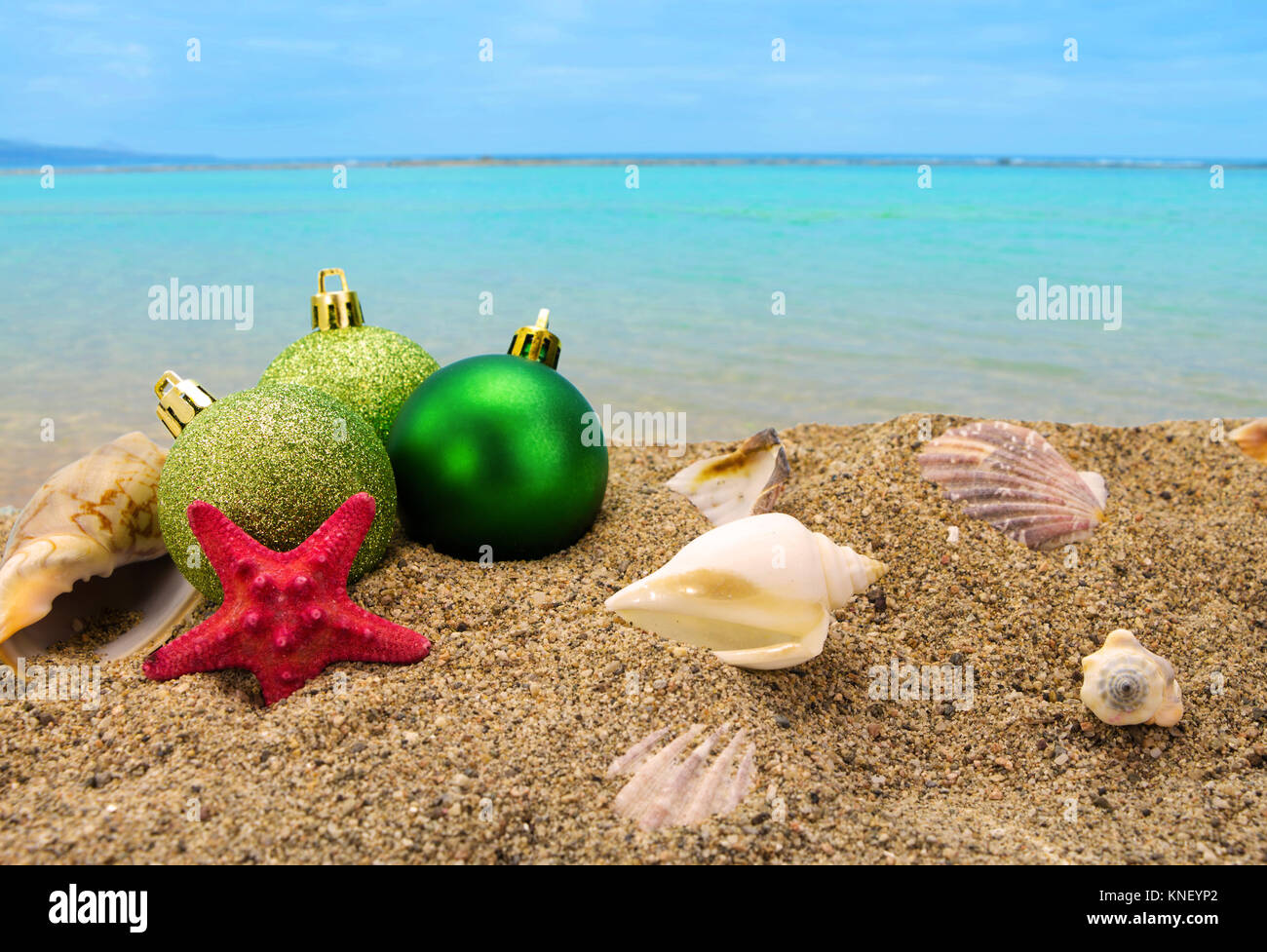 Christmas balls and shells on sand with summer sea background Stock ...